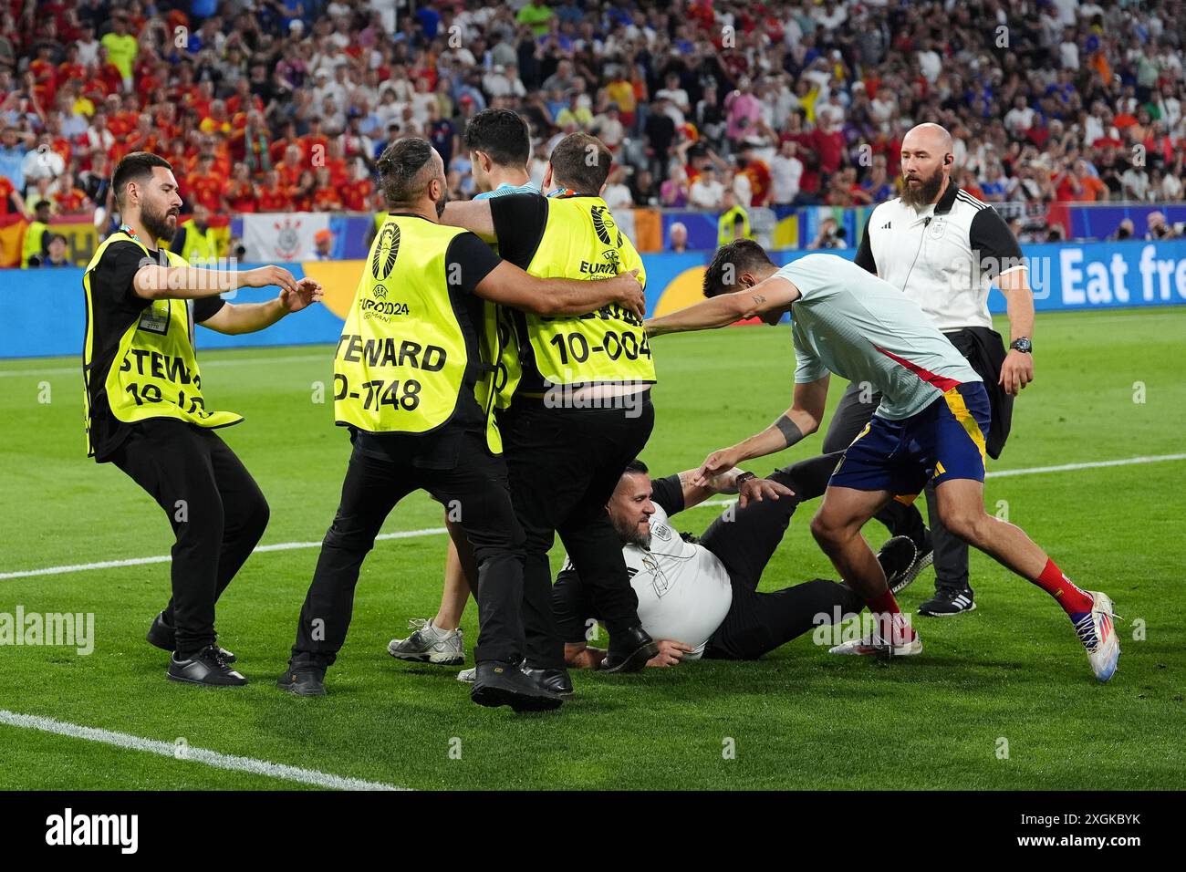 Stadium stewards tackle a pitch invader after the UEFA Euro 2024, semi ...