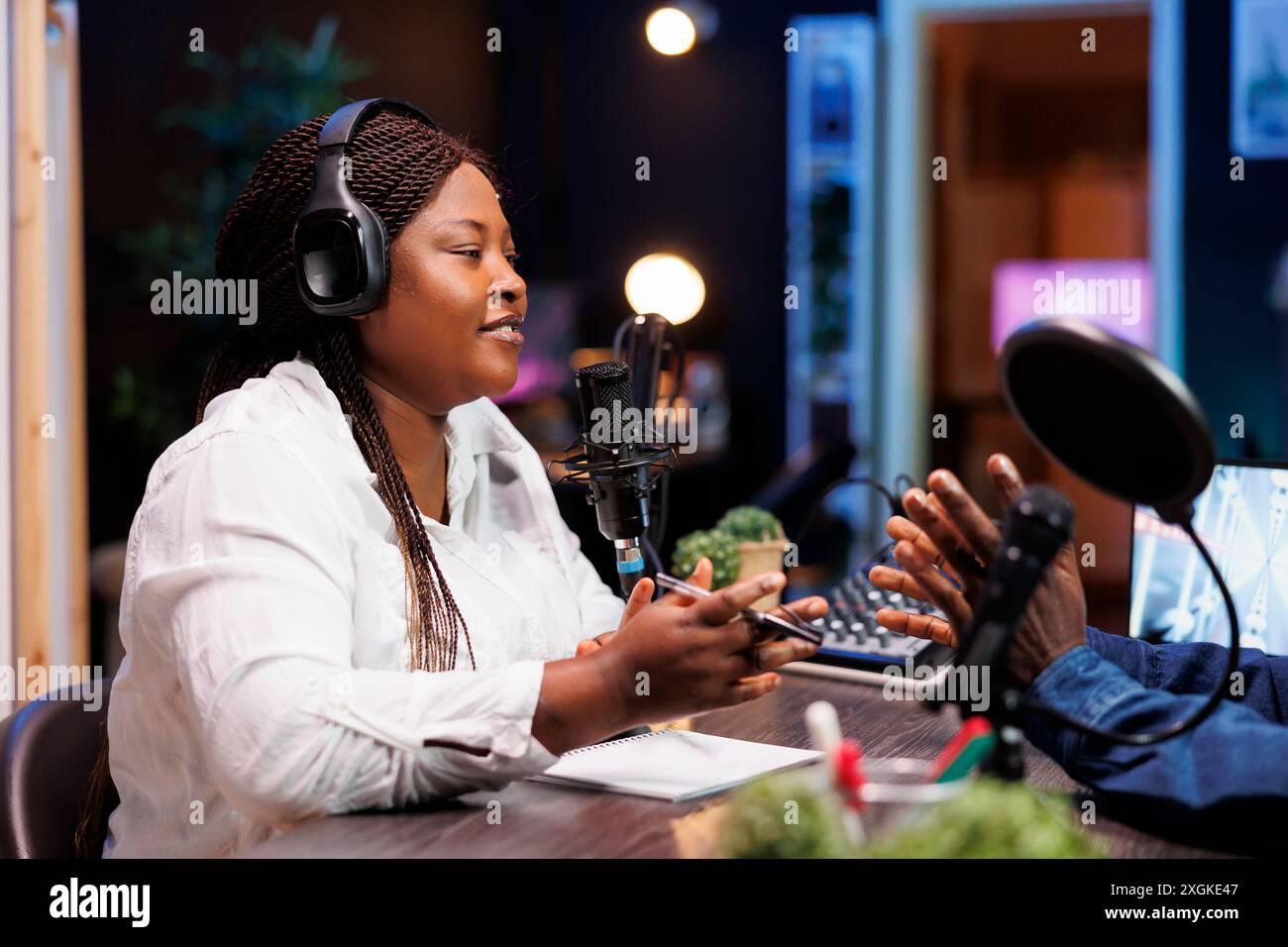 Woman radio show presenter having conversation with person, recording ...