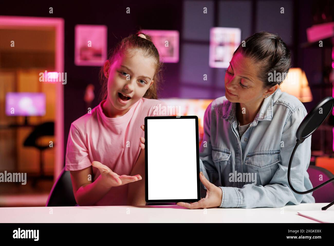 Small girl and mom using professional recording gear to film video ...