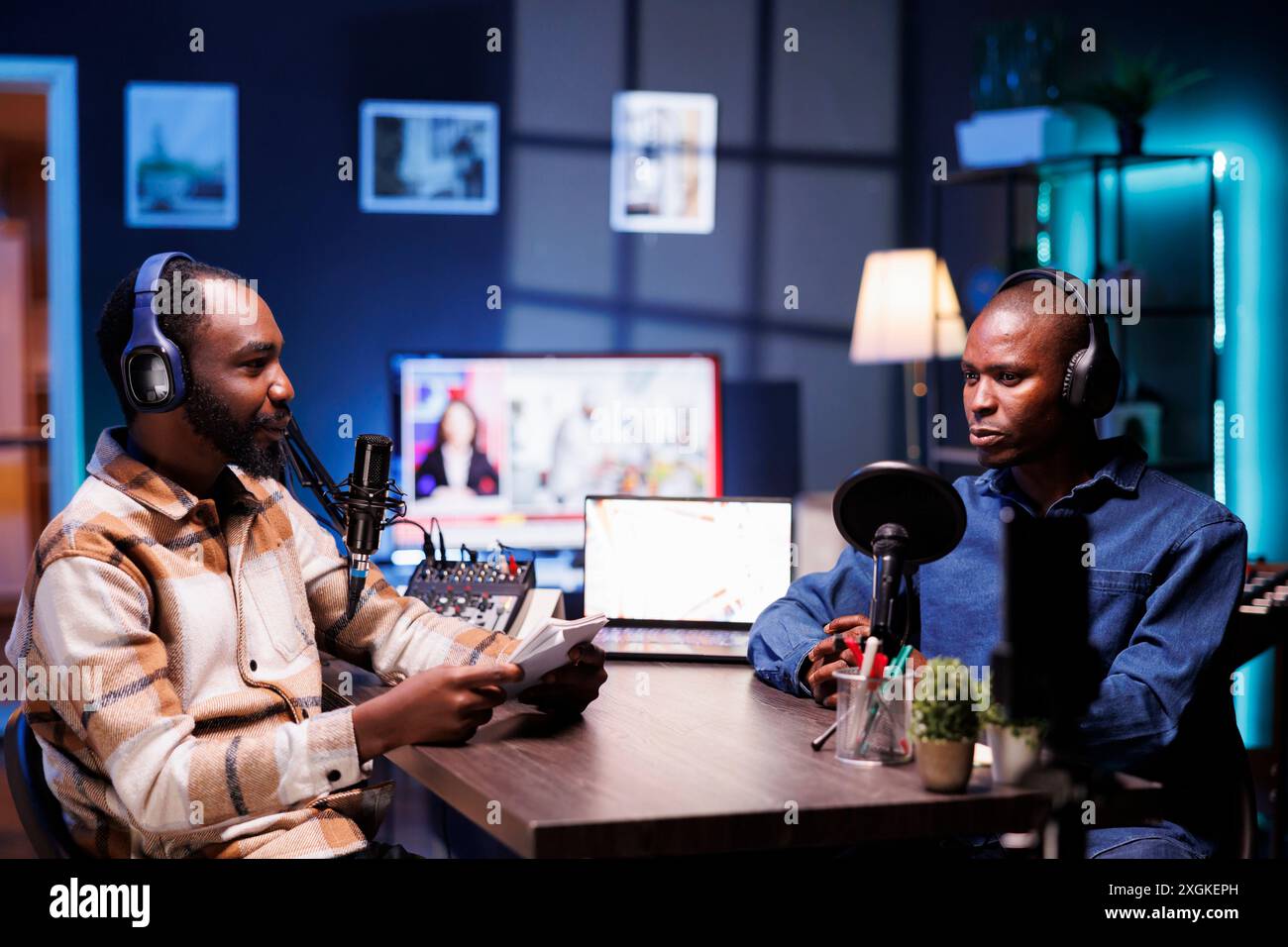 Male presenter recording live talk show using professional equipment at ...