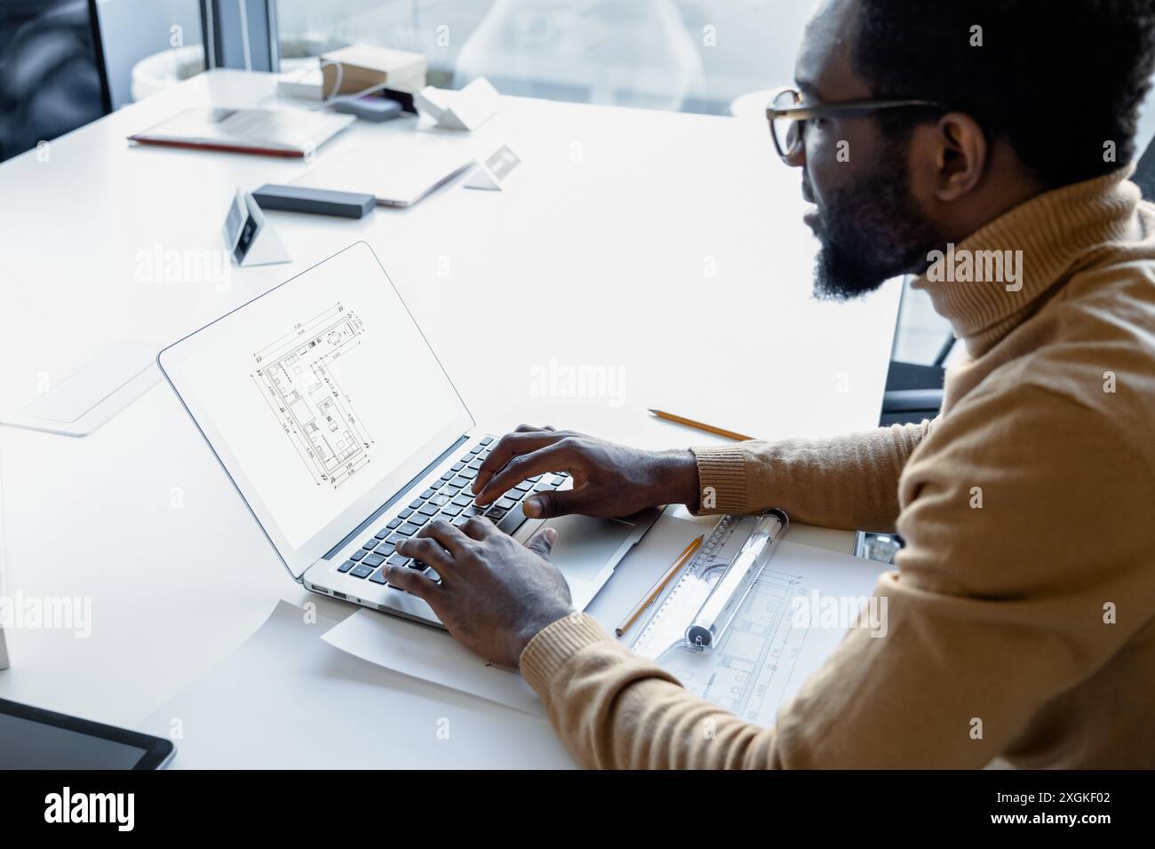 Hard working man architect handling creative projects on laptop in the ...