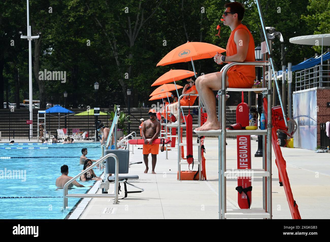 New York, USA. 09th July, 2024. A lifeguard watches as people swim in ...