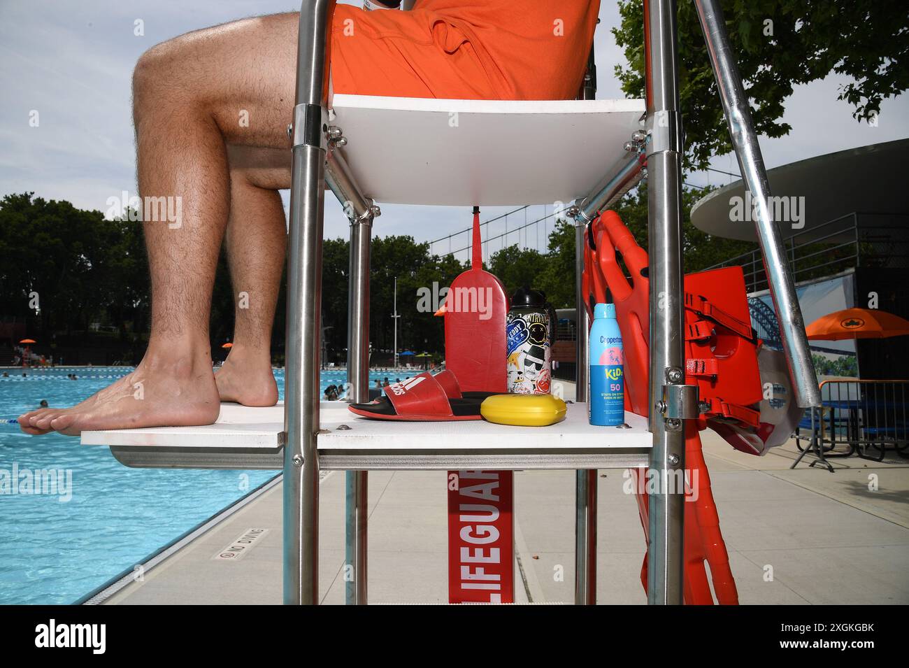 New York, USA. 09th July, 2024. A lifeguard watches as people swim in ...