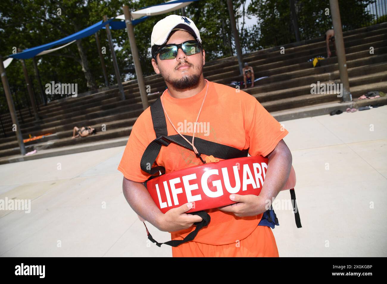 New York, USA. 09th July, 2024. A lifeguard watches as people swim in ...