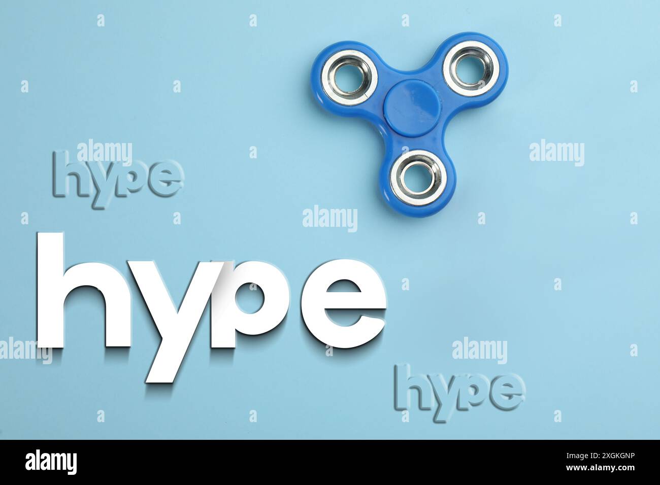 Hype words and spinner on light blue background, top view Stock Photo ...