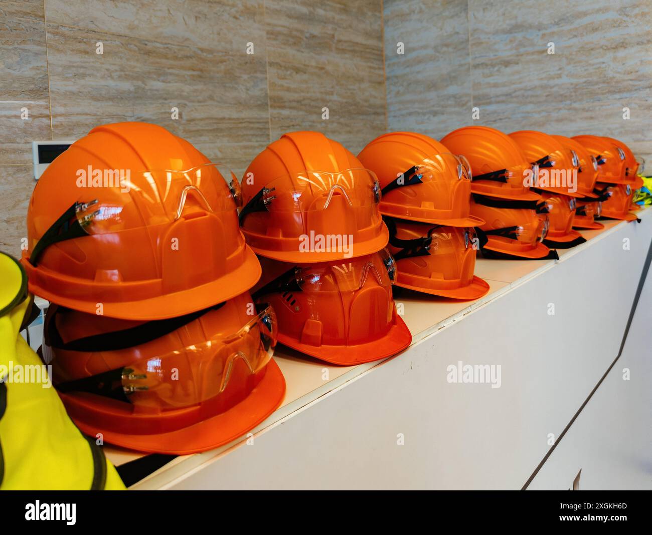 Stacks of orange safety construction helmets Stock Photo - Alamy