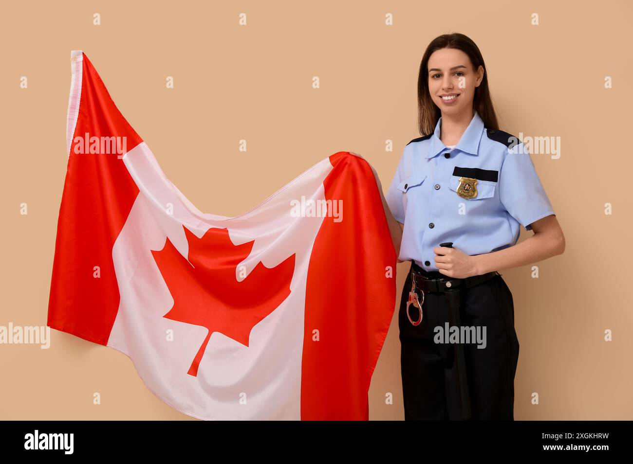 Female police officer with flag of Canada on beige background Stock ...