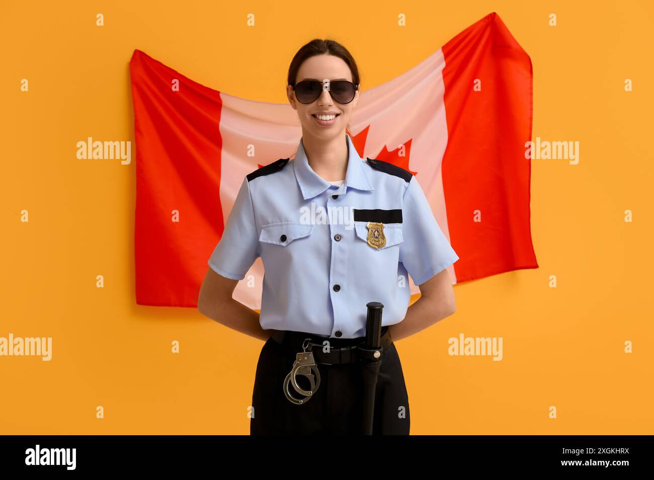 Female police officer and flag of Canada on yellow background Stock ...