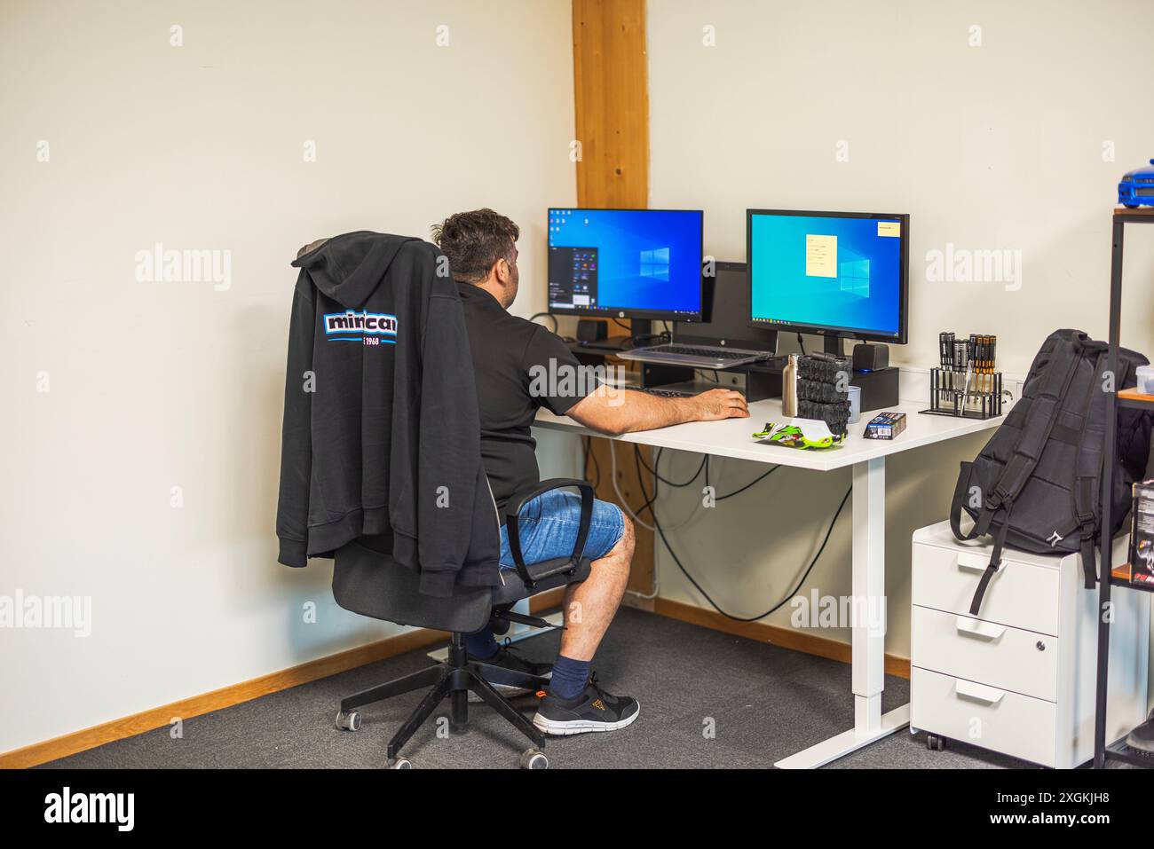 Close-up view of modern office workspace with man working at desk on ...