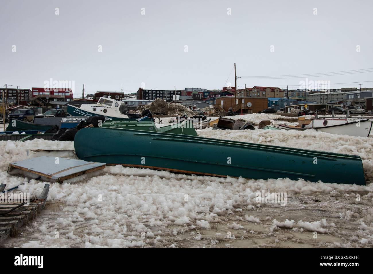 Green wooden boat stored on the beach on Frobisher Bay in Iqaluit, Nunavut, Canada Stock Photo ...