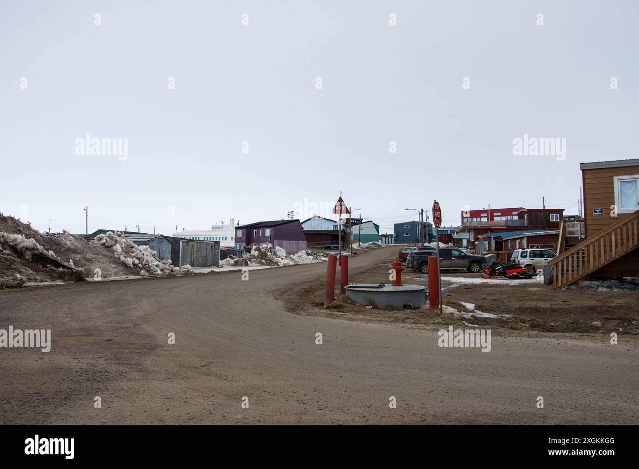 Red fire hydrant protected by bollards in Iqaluit, Nunavut, Canada ...