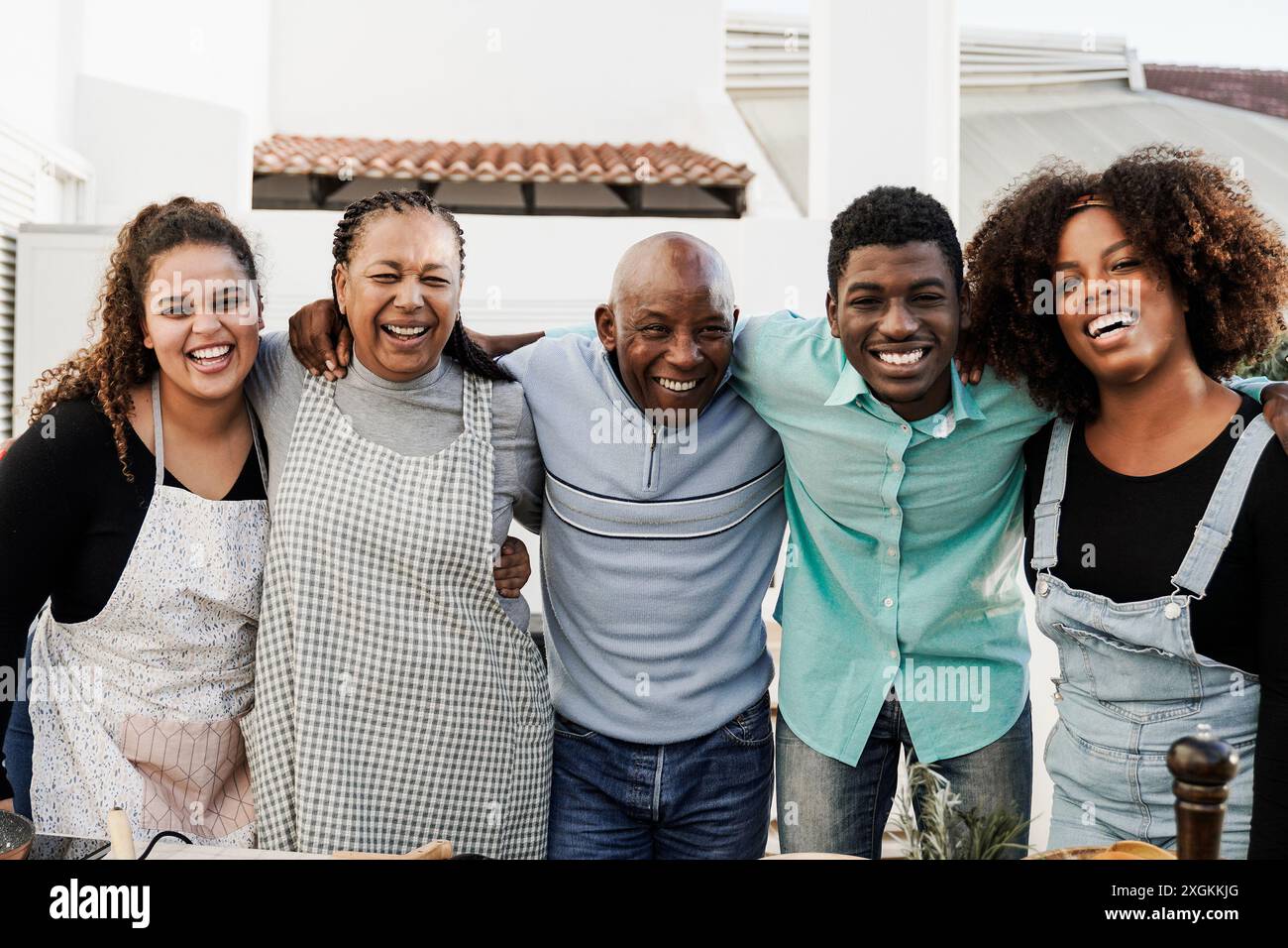 Kitchen outdoor: African family cooking food at home patio. Father ...