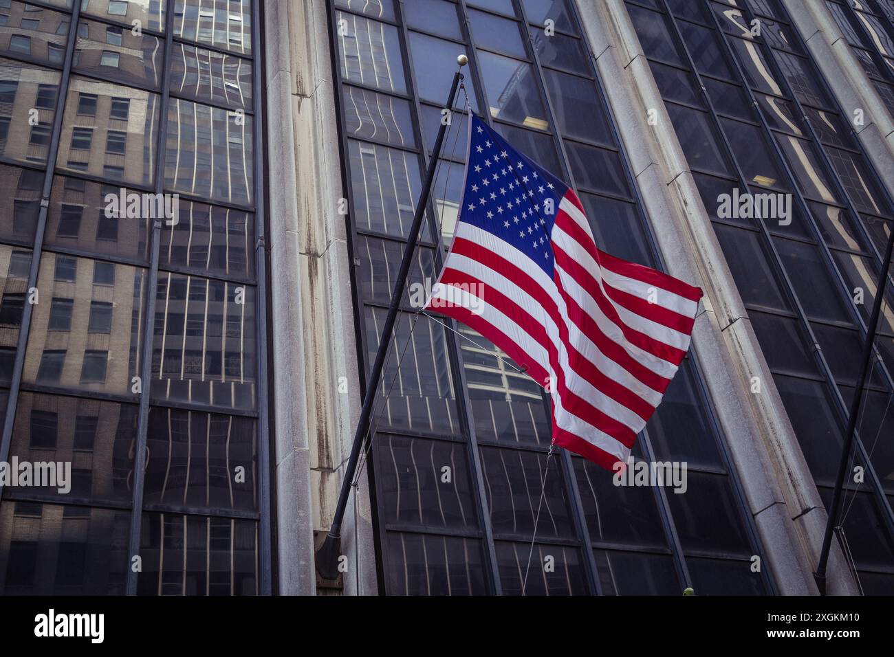 American Flag Flying from the side of a New York Building Stock Photo ...
