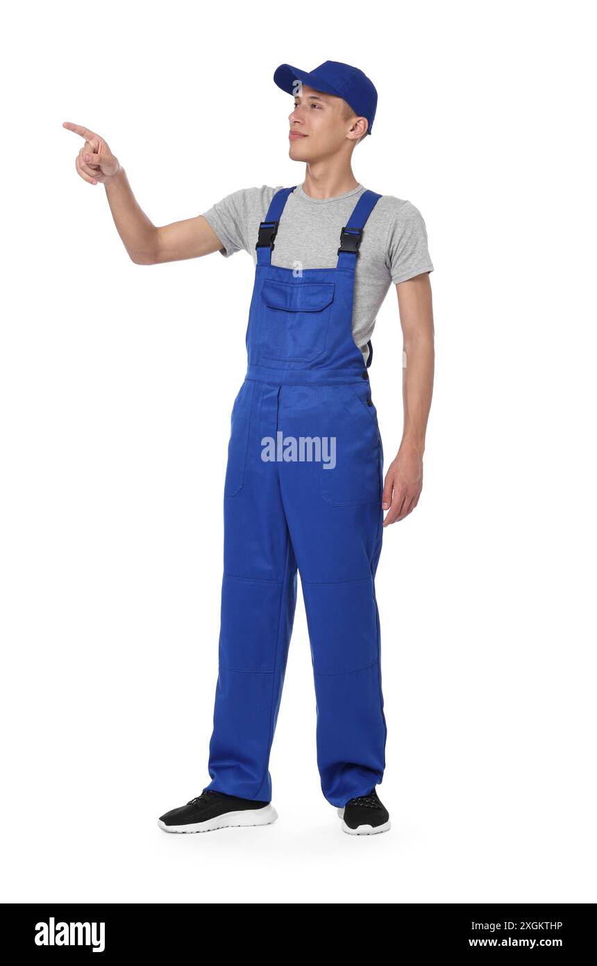 Auto mechanic pointing at something on white background Stock Photo - Alamy