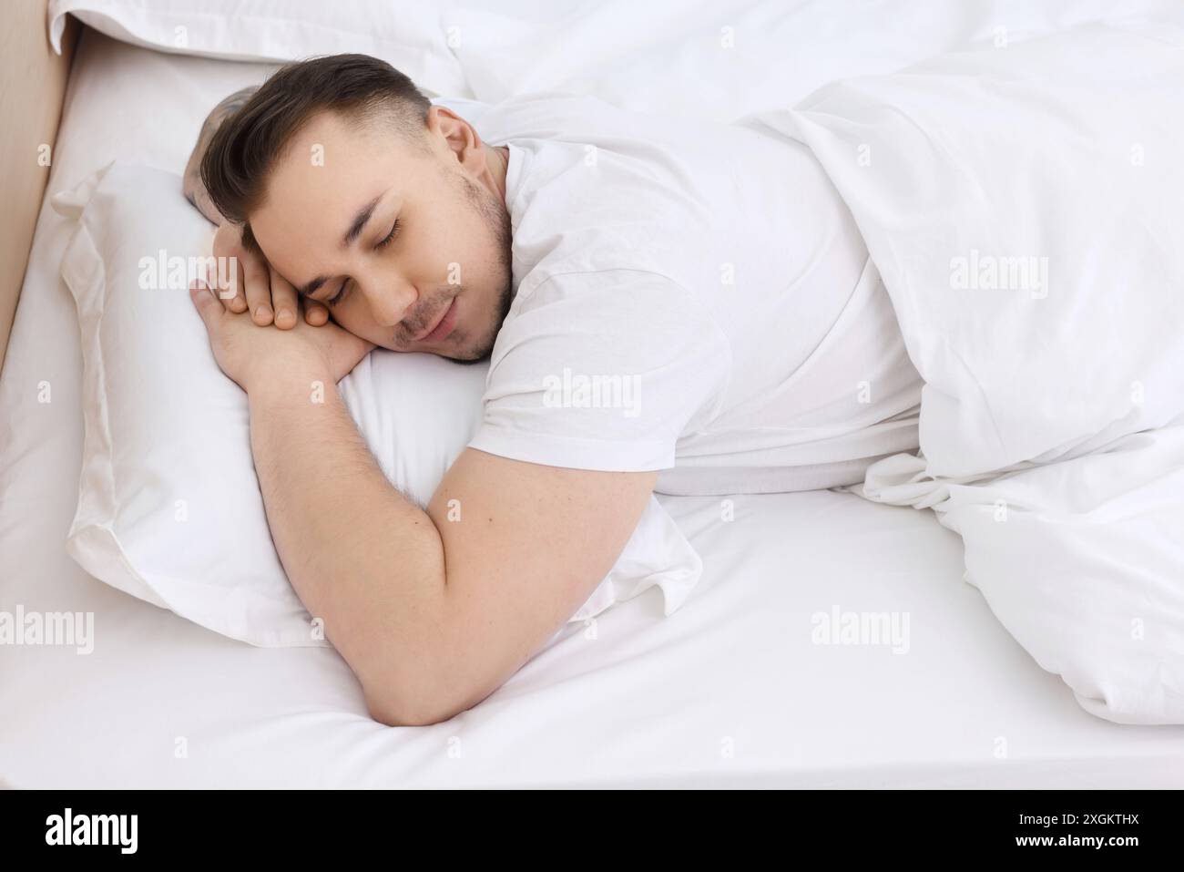 Bedtime. Handsome man sleeping in bed indoors Stock Photo - Alamy