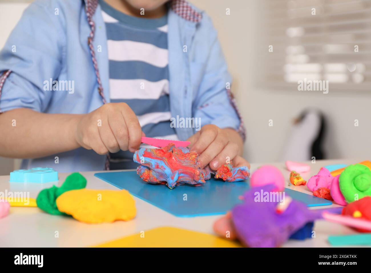 Little boy sculpting with play dough at table indoors, closeup Stock ...