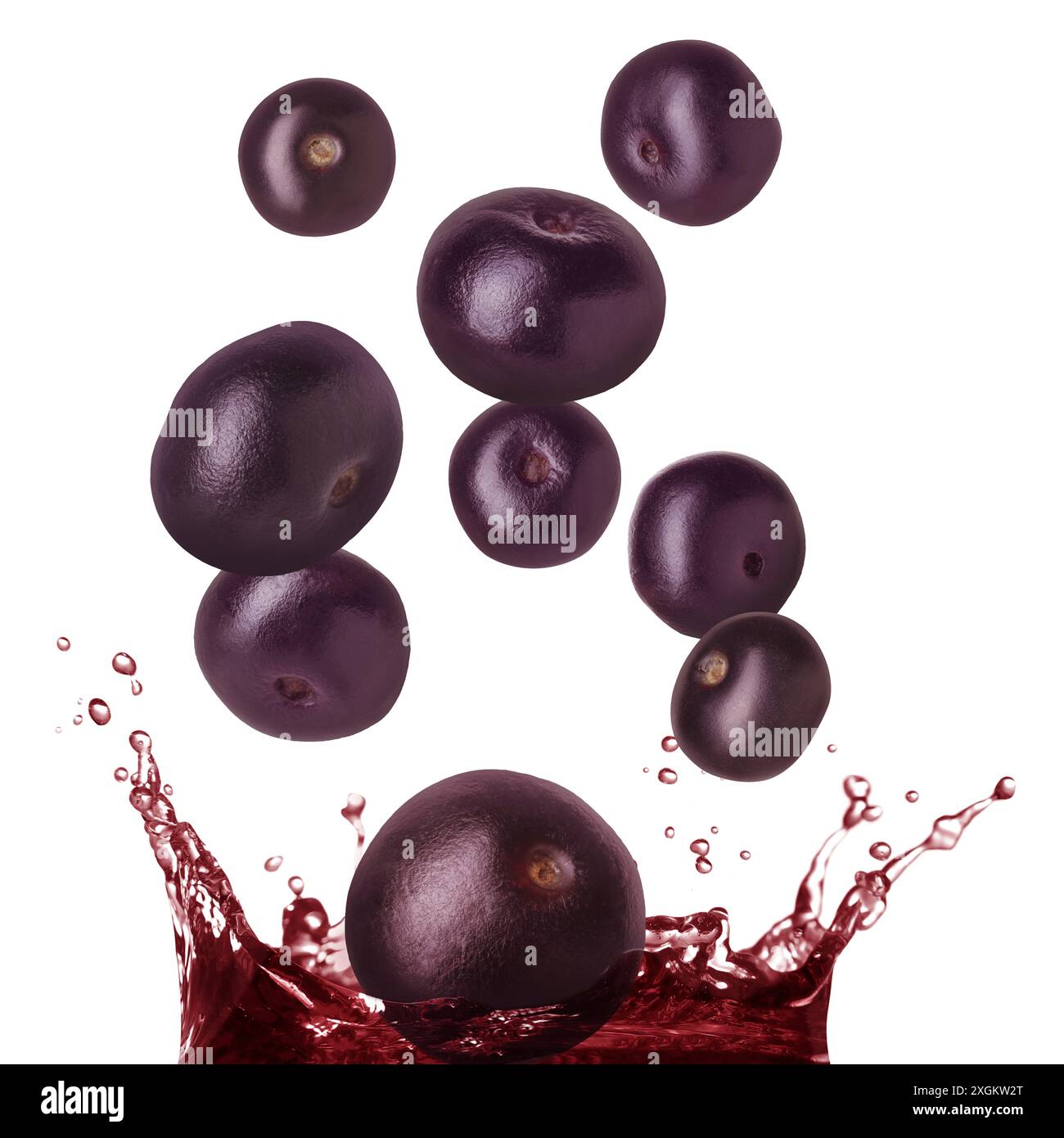 Acai berries falling into juice on white background Stock Photo - Alamy