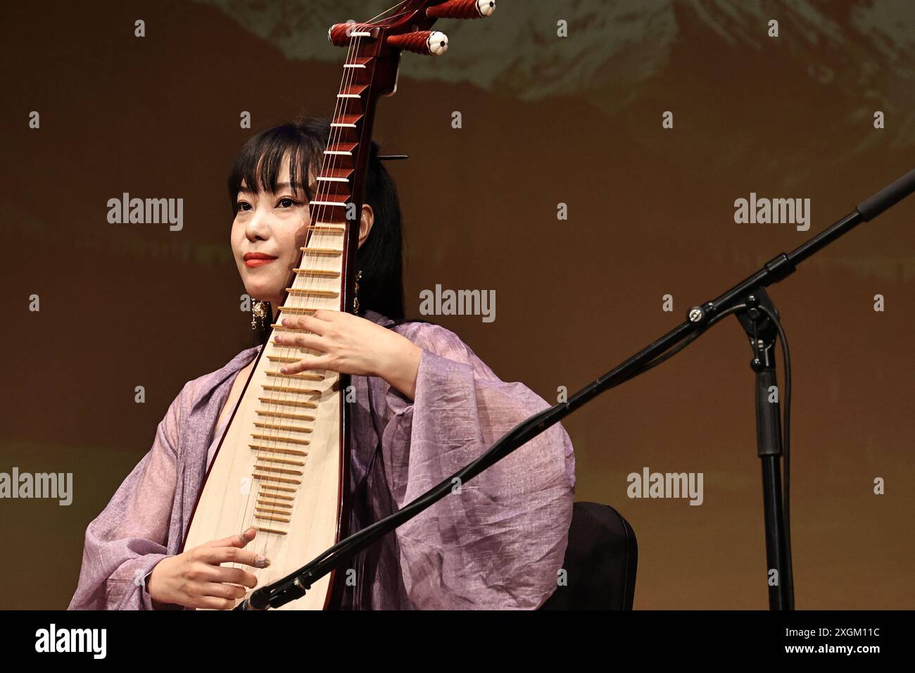 Rabat, Morocco. 8th July, 2024. A Chinese artist performs with pipa, a ...