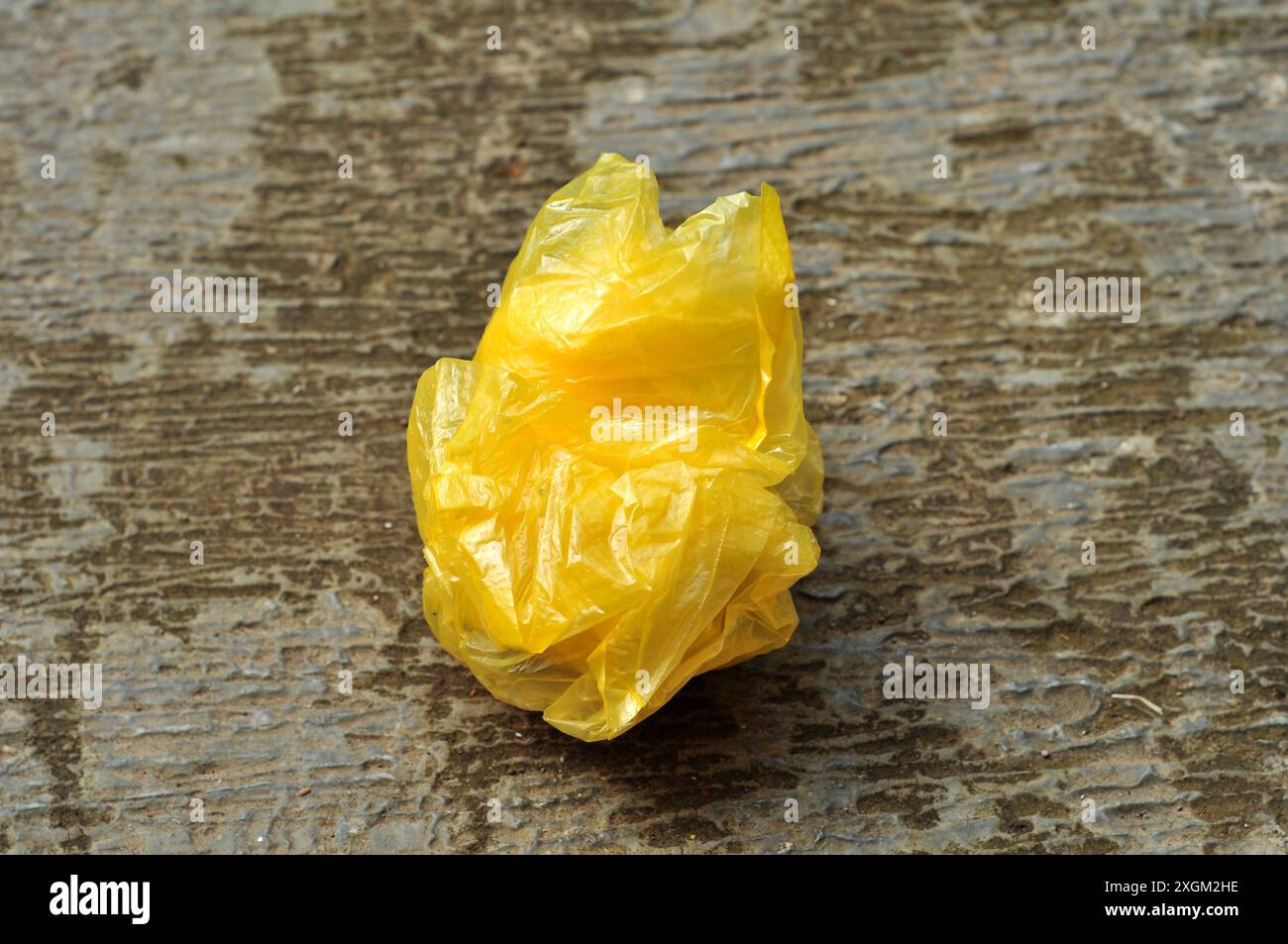 Yellow plastic bag waste pollutes the environment Stock Photo - Alamy