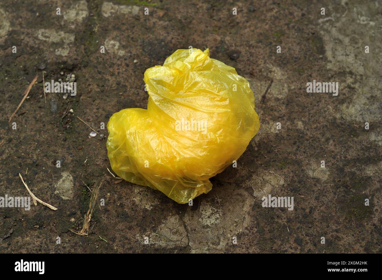 Yellow plastic bag waste pollutes the environment Stock Photo - Alamy