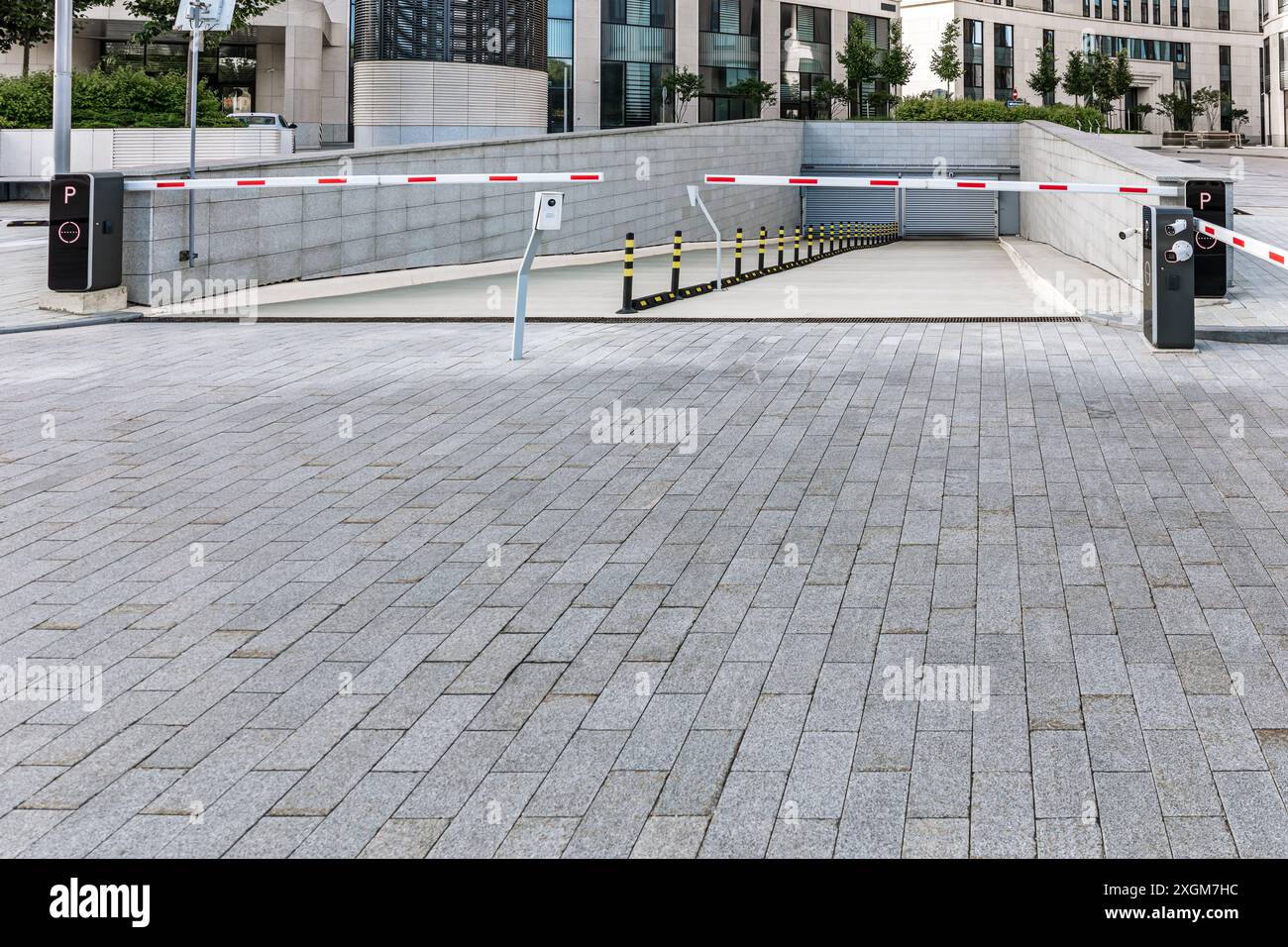 underground garage parking entrance with closed automatic boom barrier ...