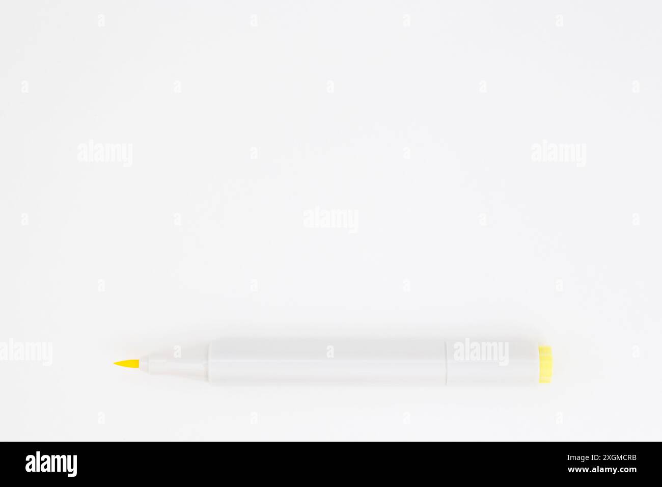 opened yellow marker laying on blank white page of sketch book Stock ...