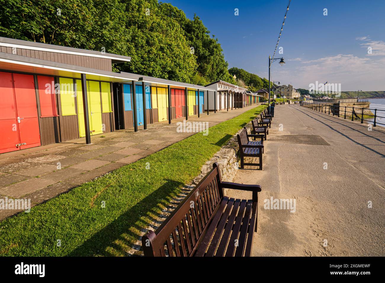 Early morning light in the beach huts and promenade at Filey in North ...