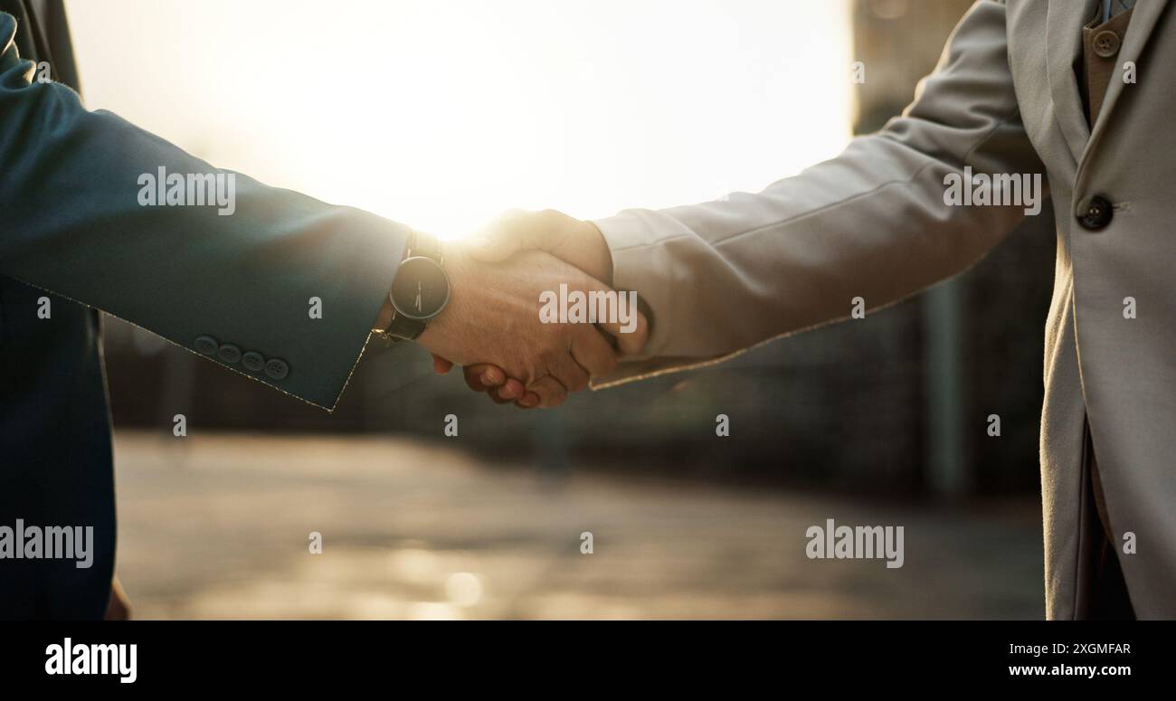 Closeup, handshake and business people in city, agreement and ...