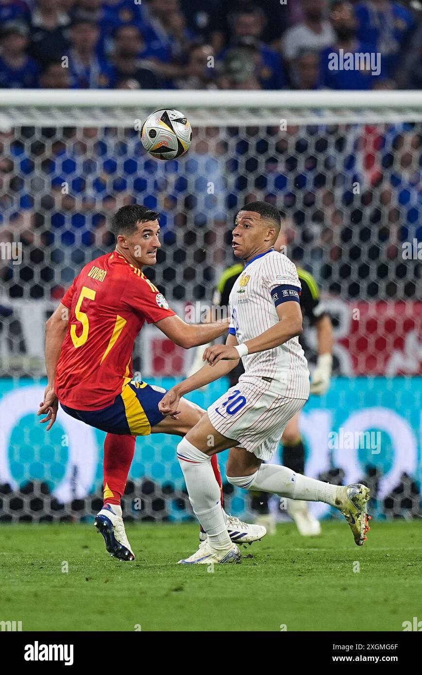 Munich, Germany. 9th July, 2024. Kylian Mbappe (R) of France vies with Daniel Vivian of Spain ...