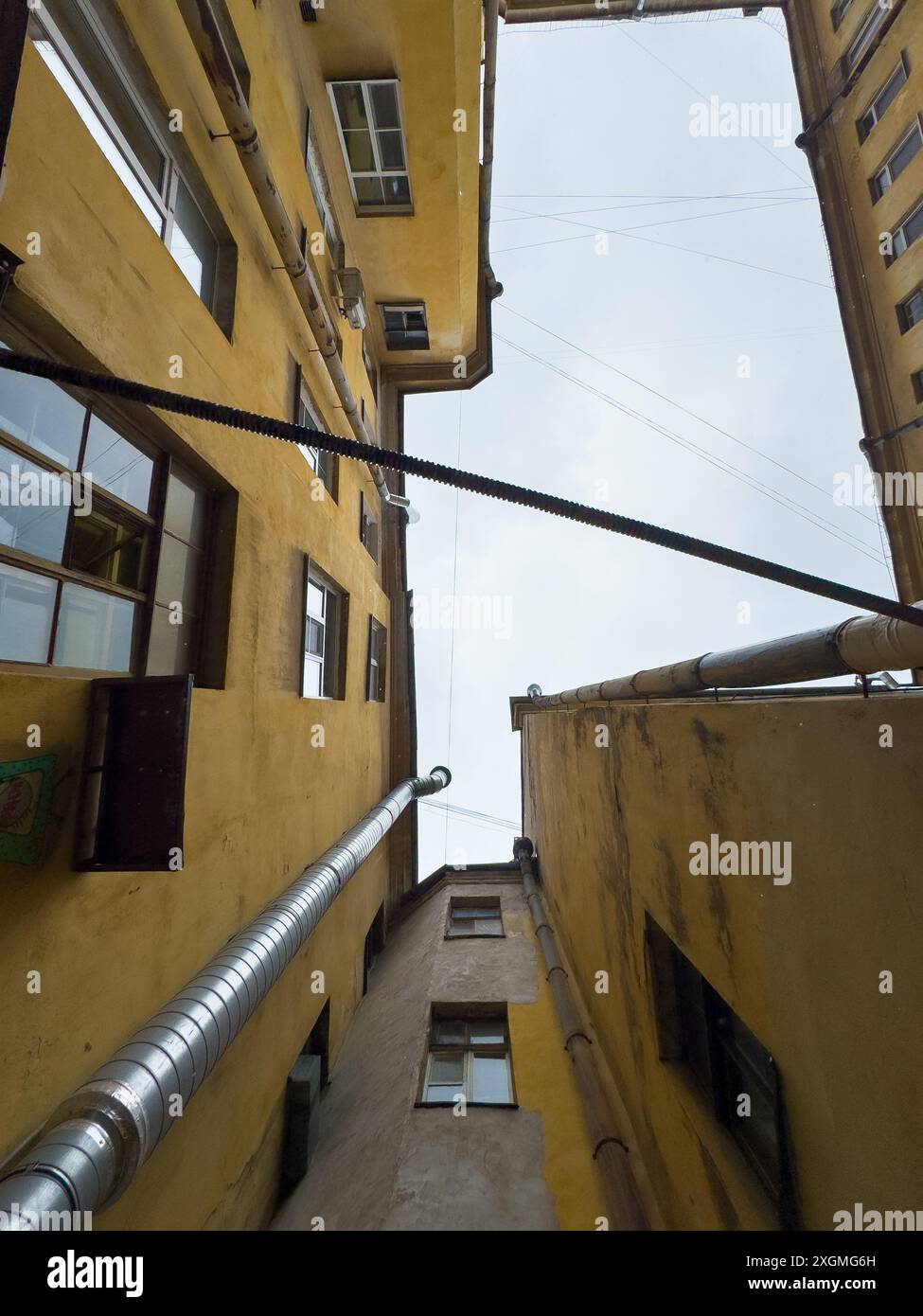 Upward view of tightly spaced yellow buildings in an urban area ...