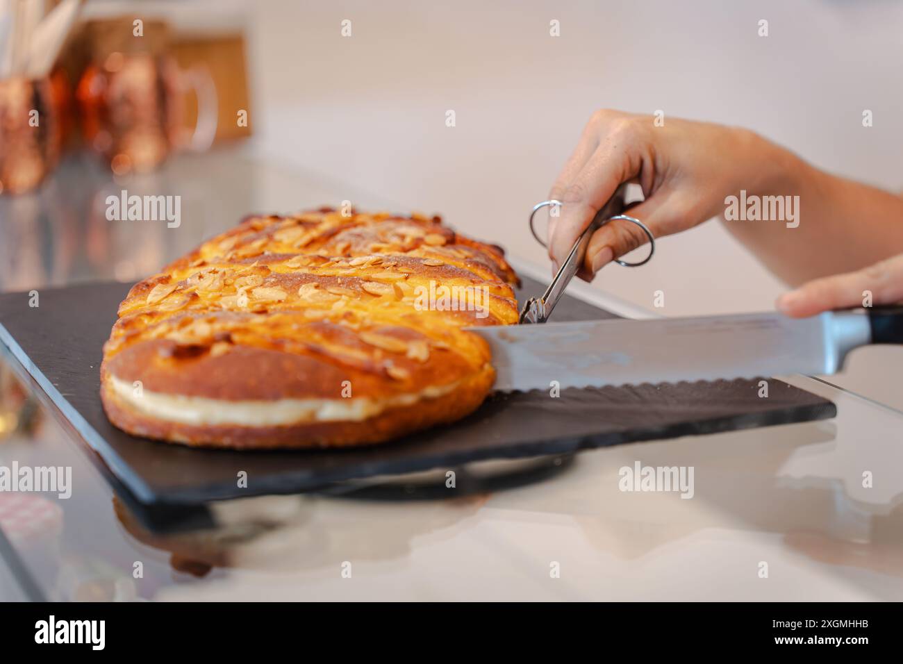 Woman's hands cutting a traditional cake in a bakery. Vertical Stock ...