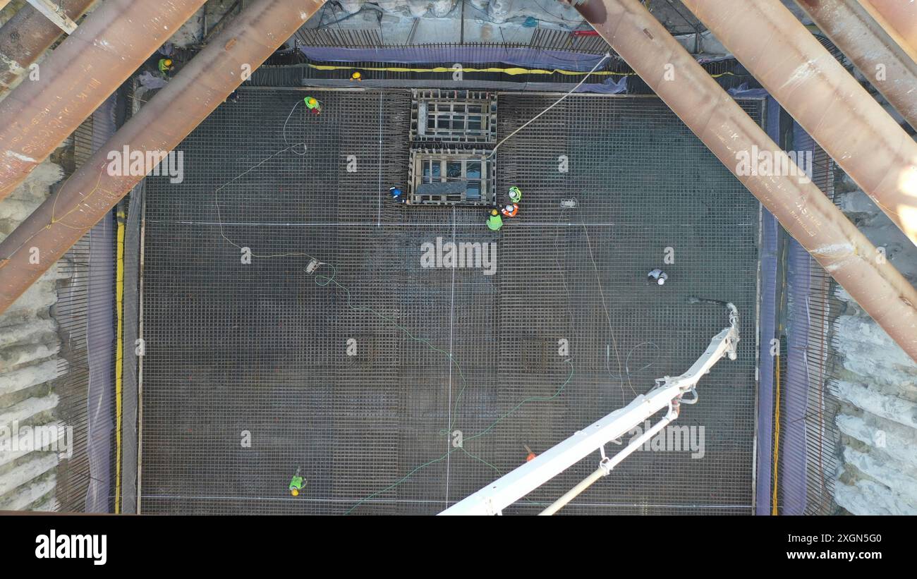 Aerial view of a construction site showing workers and reinforced ...