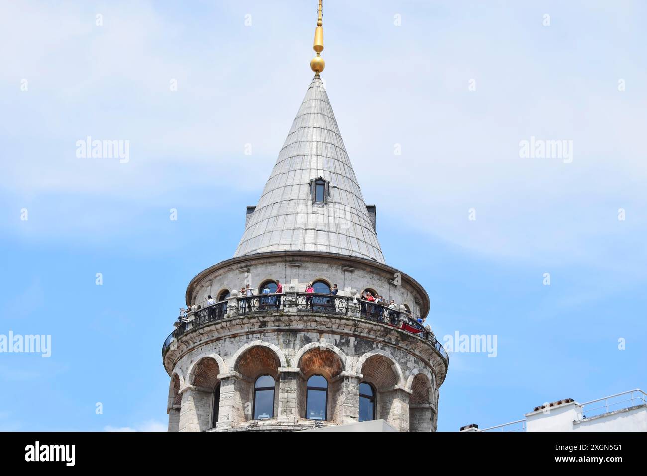 Historic tower with a pointed spire and observation deck under a blue ...