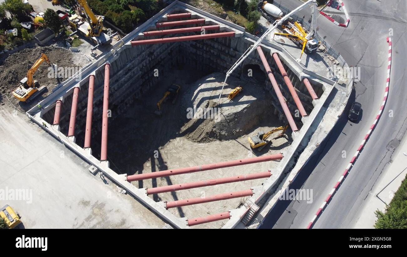 Aerial view of an urban construction site with multiple excavators and ...