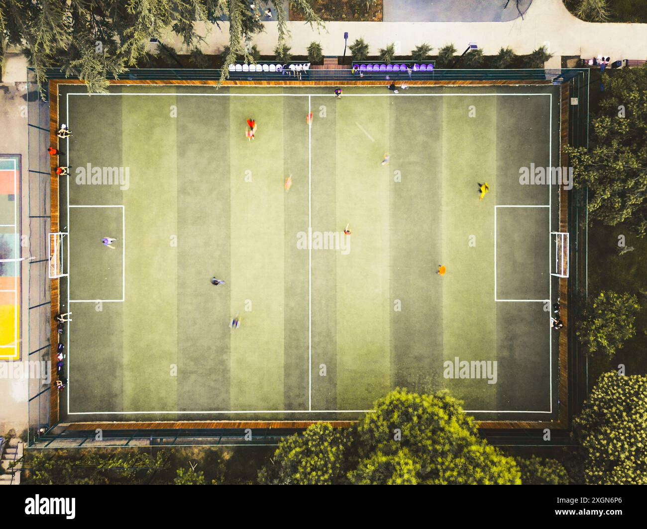 Aerial top down motion blur view boys footballer teams compete play ...