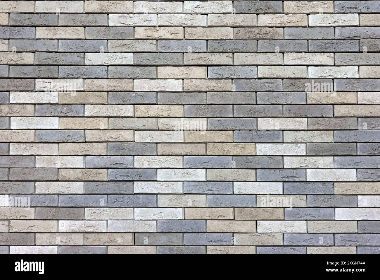 Wall from motley beige decorative spotted bricks horizontal photo front ...