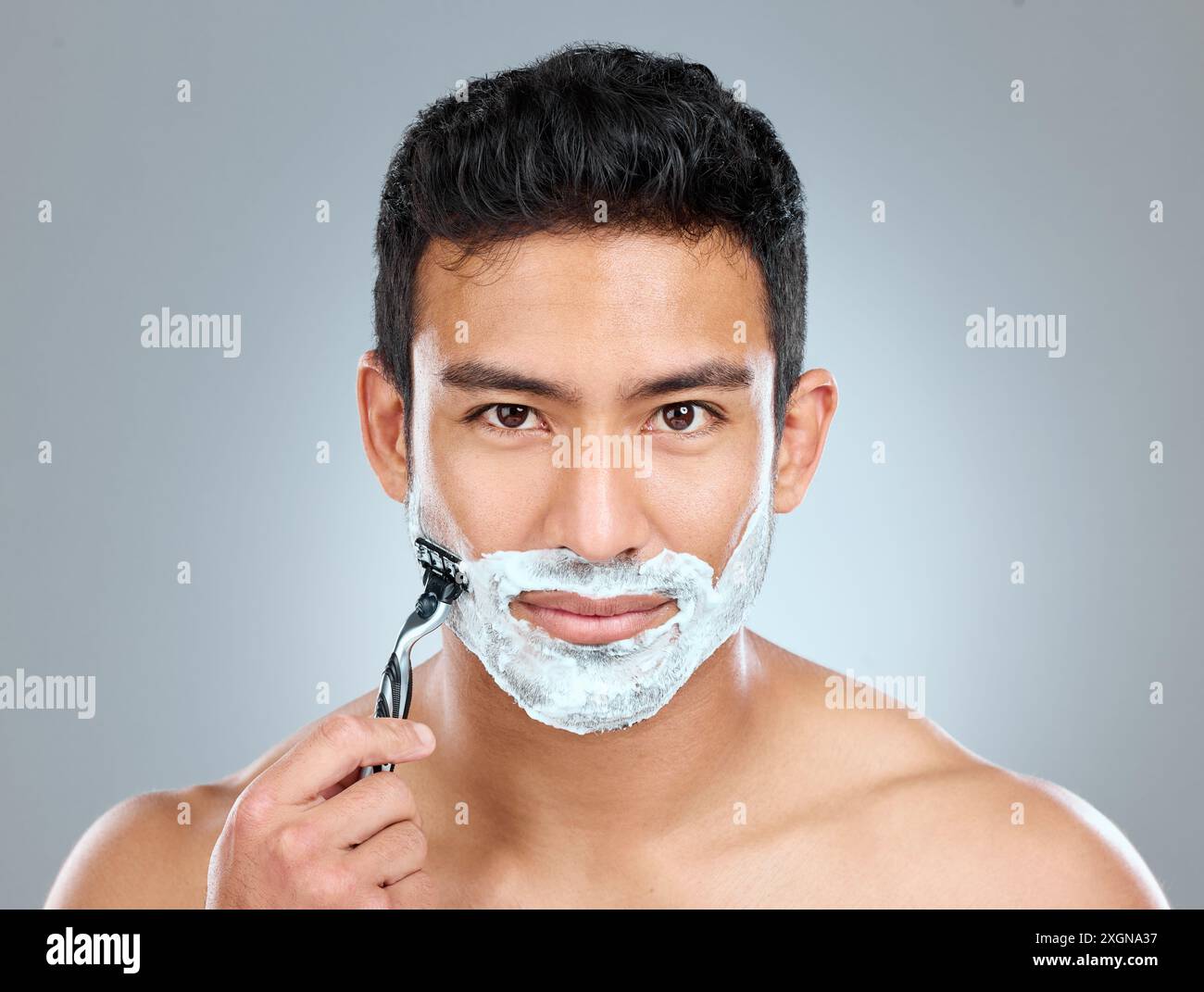 Portrait, shaving and skincare with masculine man in studio on gray background for cosmetic ...
