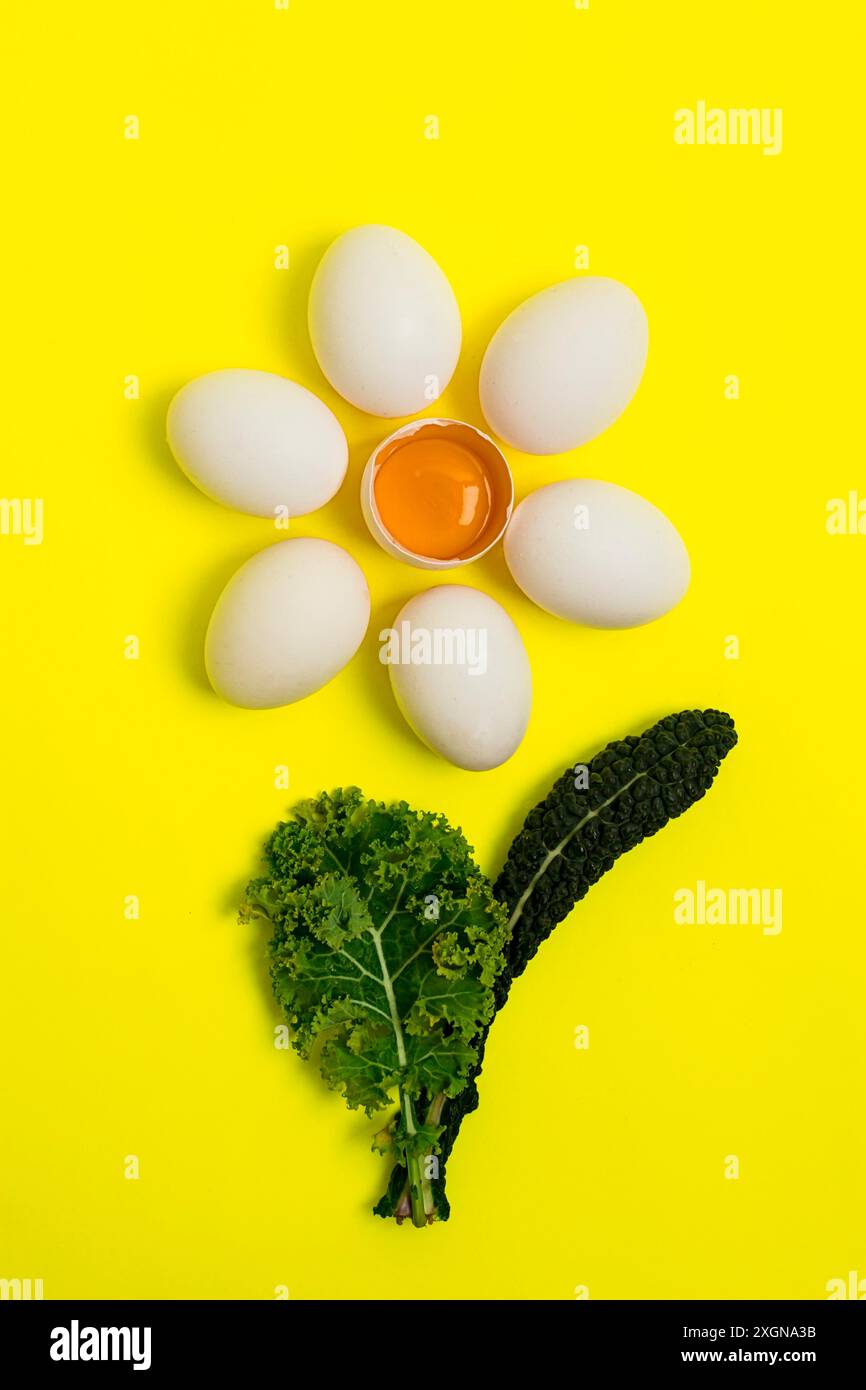 Fresh eggs, on a yellow background, in the shape of a chamomile with ...