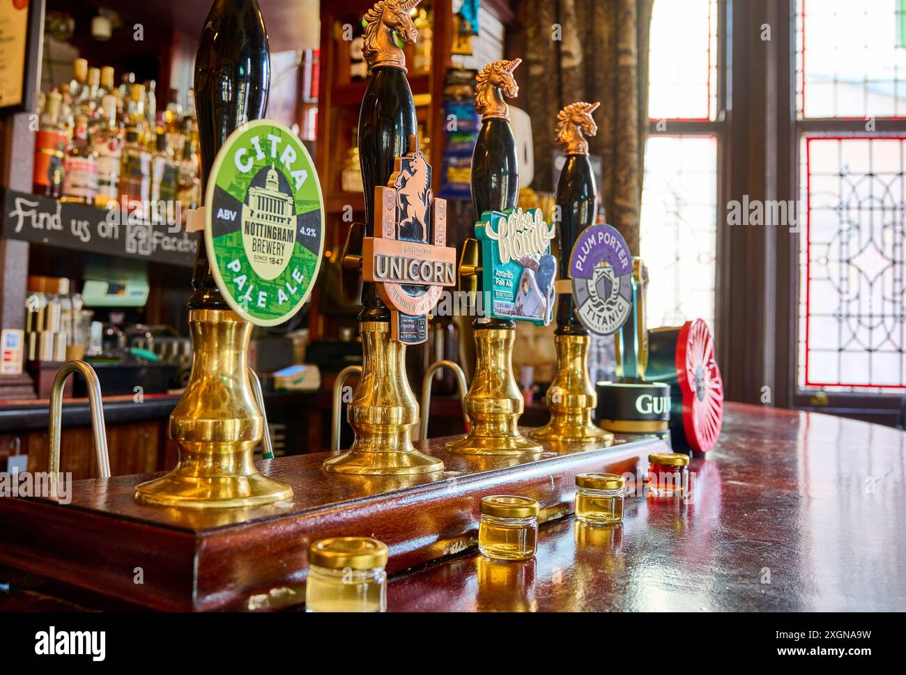 Hand pull beer pumps on the bar of the Black Horse pub in Preston city ...