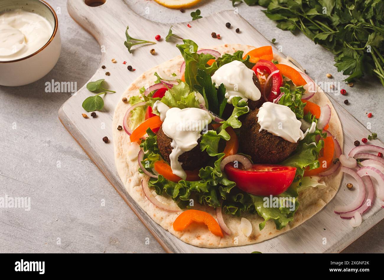 Tortilla with falafel and vegetable salad, white sauce, Arabic cuisine ...