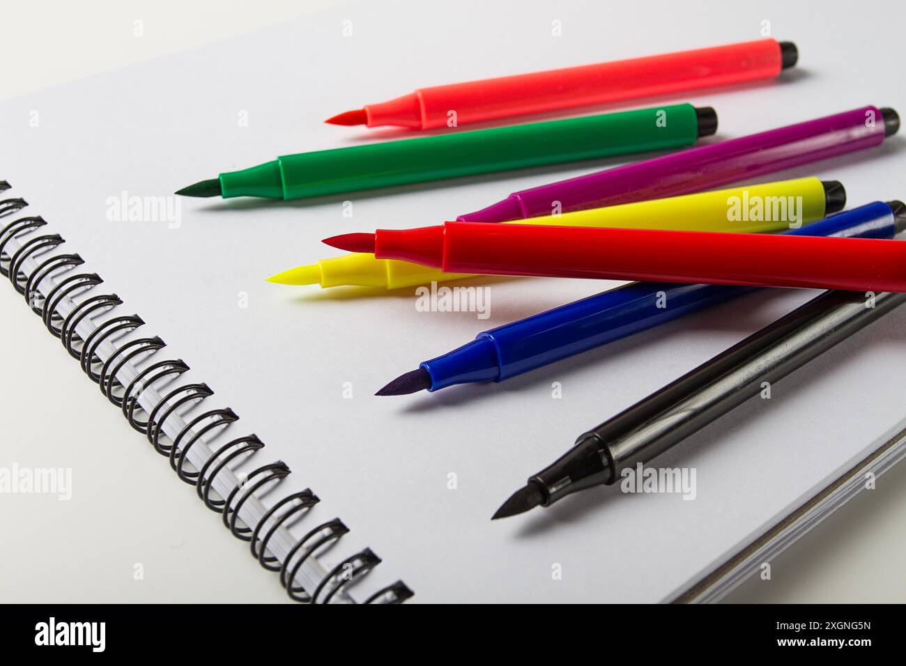 Watercolor pens brush, assortment, on a drawing album, artist's desk ...