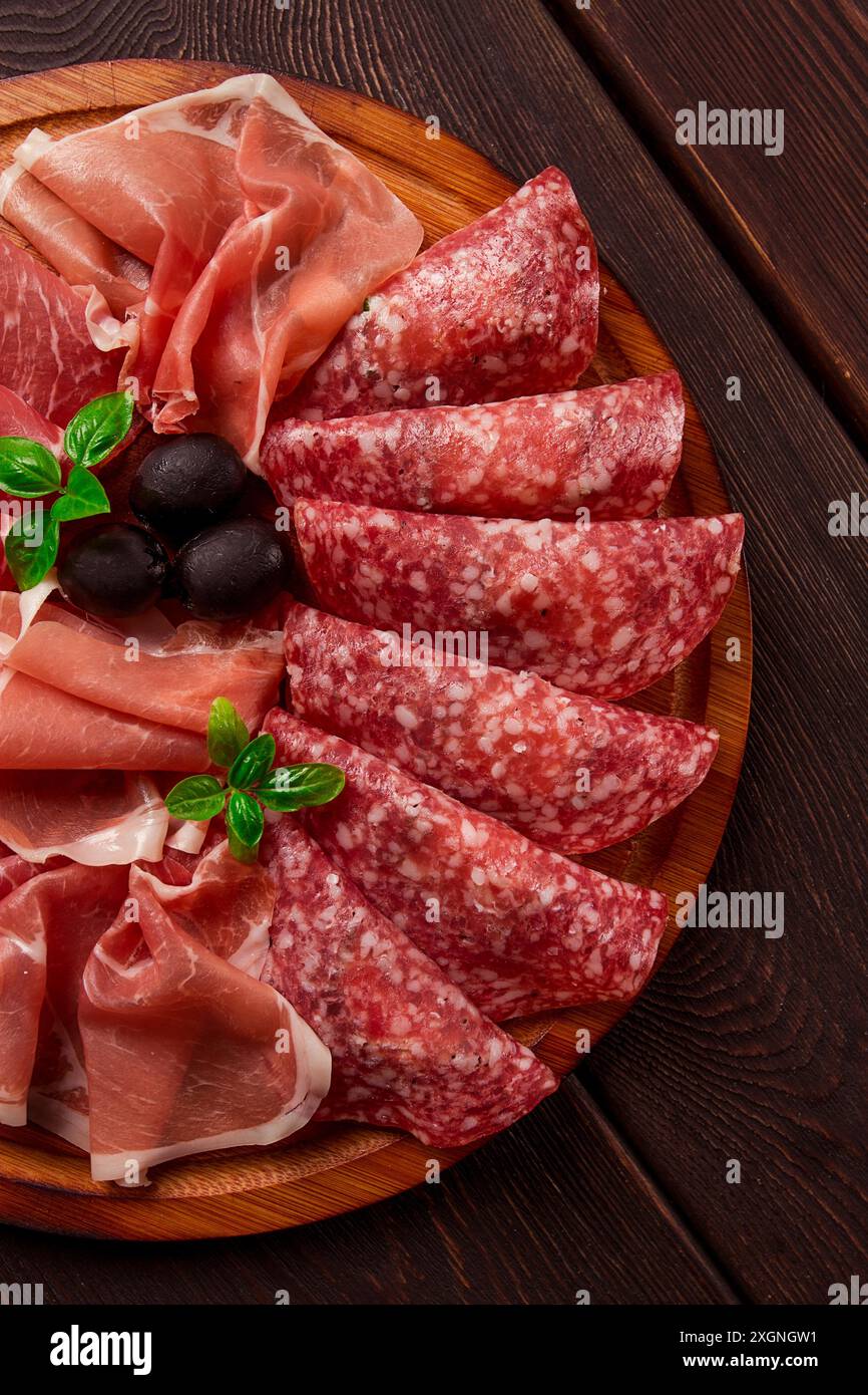 Assortment, sliced meat appetizer, prosciutto, salami and ham, with ...