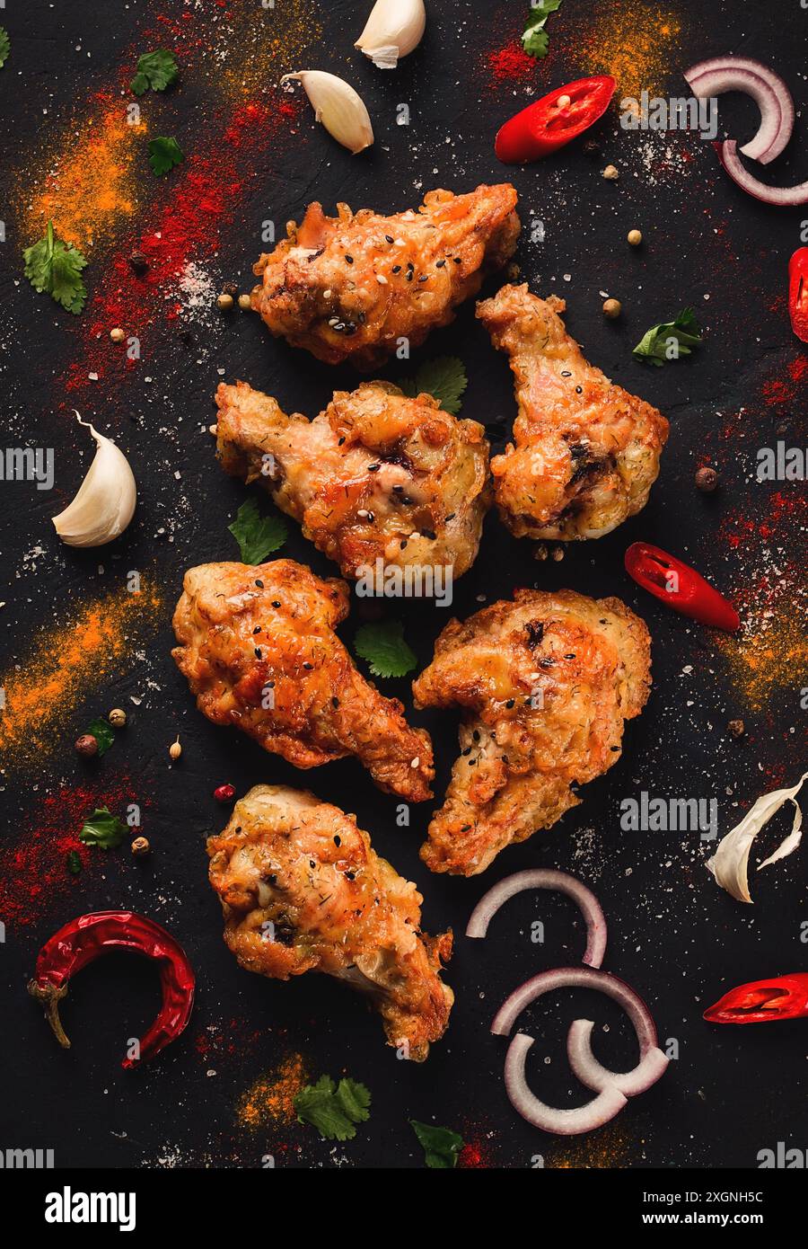 Fried chicken legs, breaded, with spices and herbs, on a dark ...