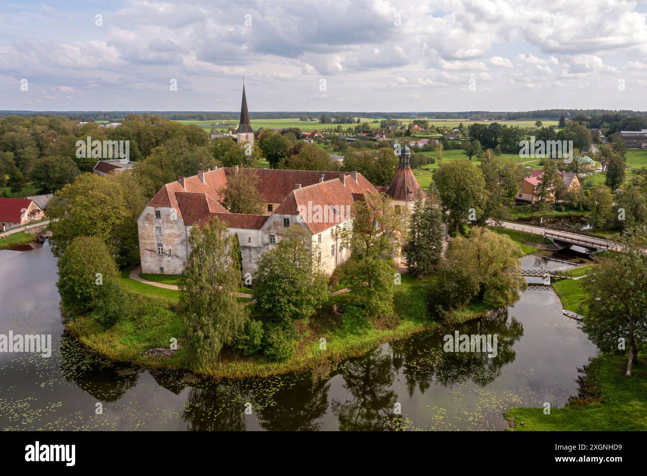 Stone castle on an island surrounded by water and trees Stock Photo - Alamy