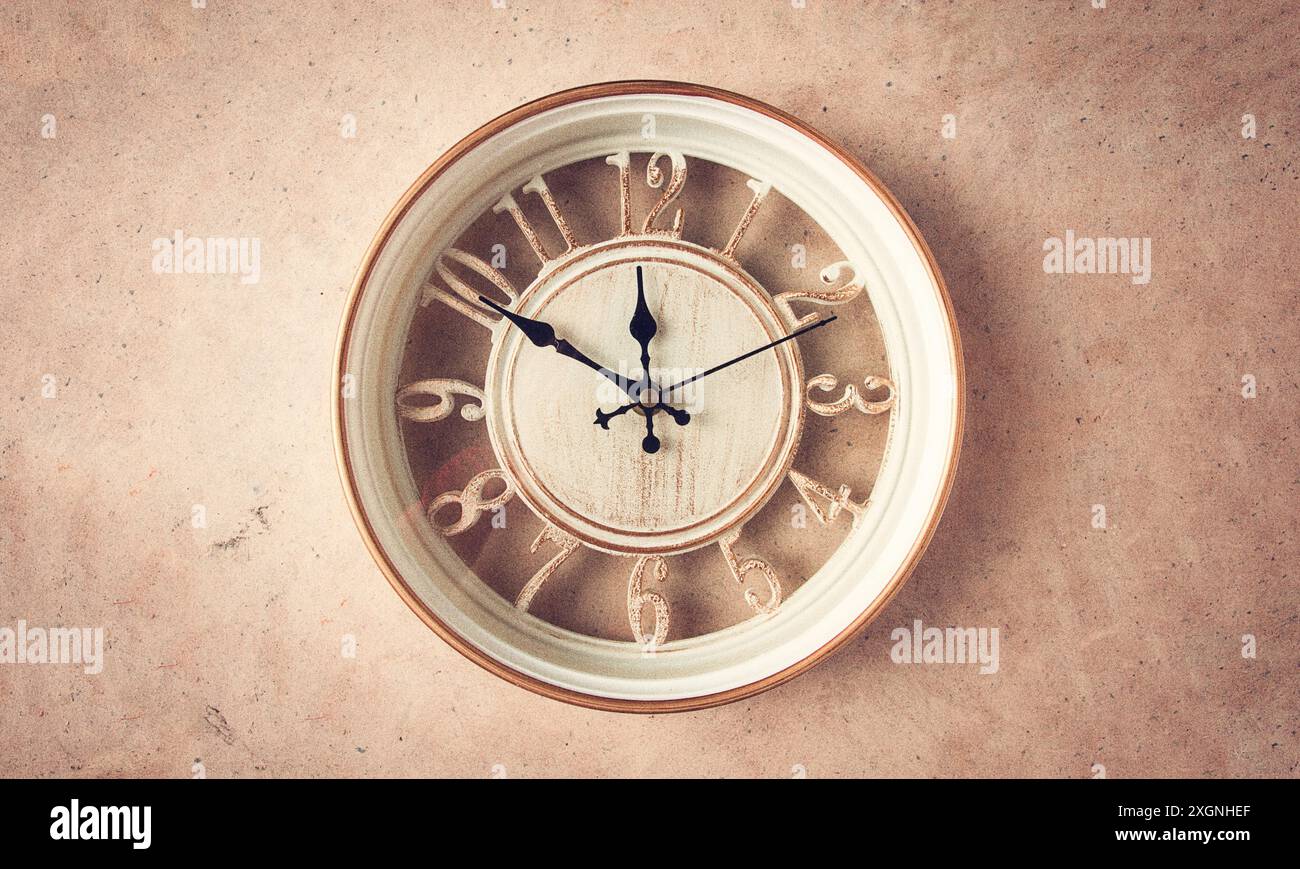Mechanical wall clock, transparent, beige color, on a light painted ...