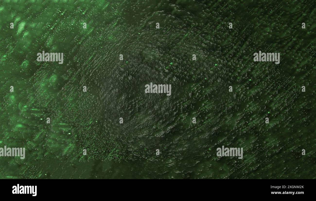 A green textured abstract image with a swirling pattern and light spots ...