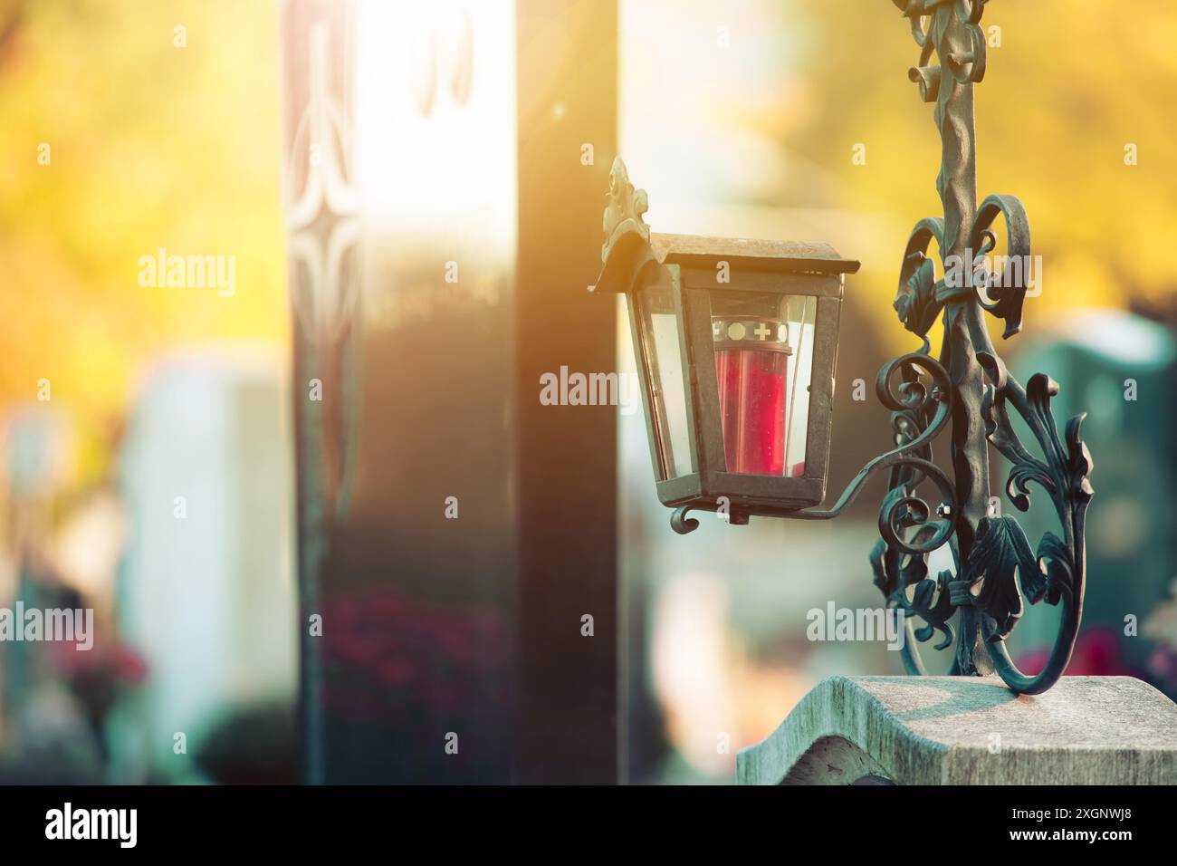 Candle in an iron lantern on a grave at a cemetery Stock Photo - Alamy