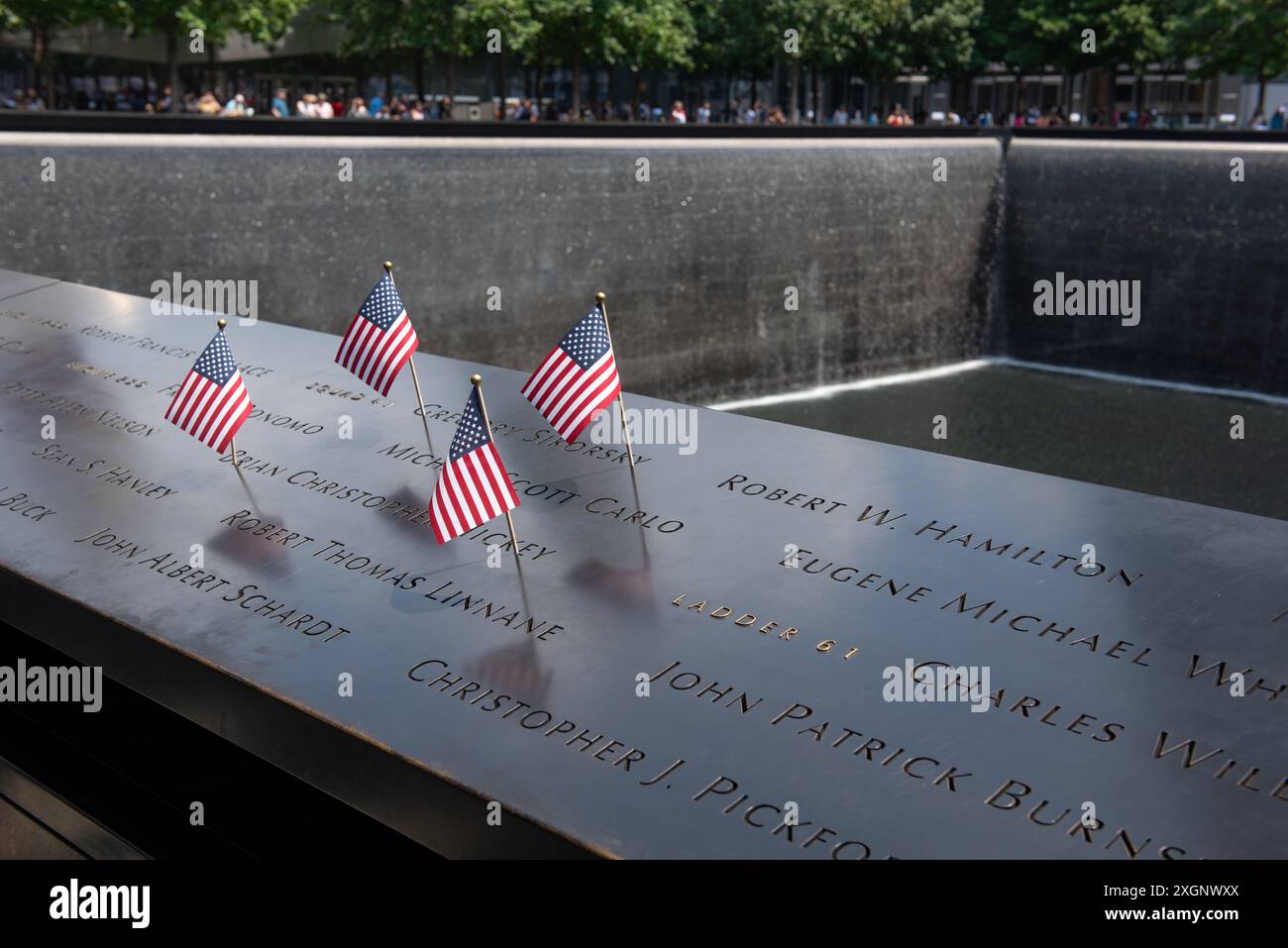 Miniature Stars and Stripes flags mark the names of the remembered at ...