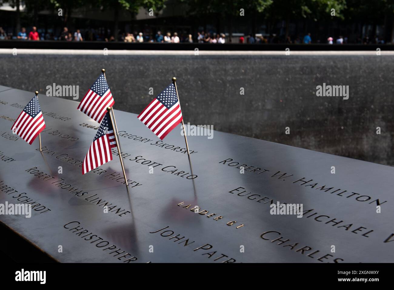 Miniature Stars and Stripes flags mark the names of the remembered at ...