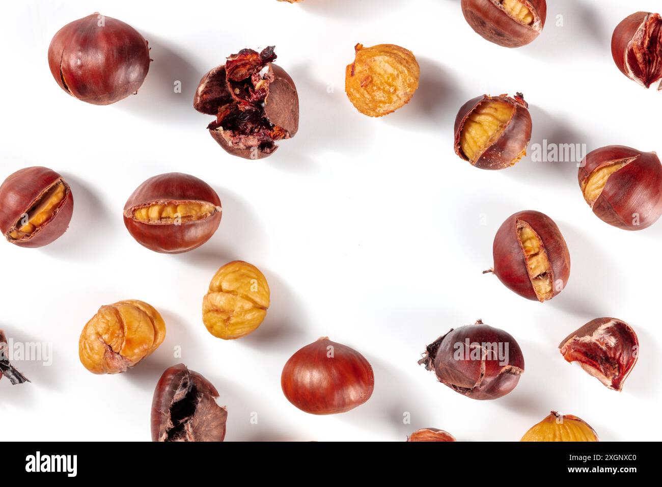 Chestnuts, forming a frame for copy space, top shot on a white ...
